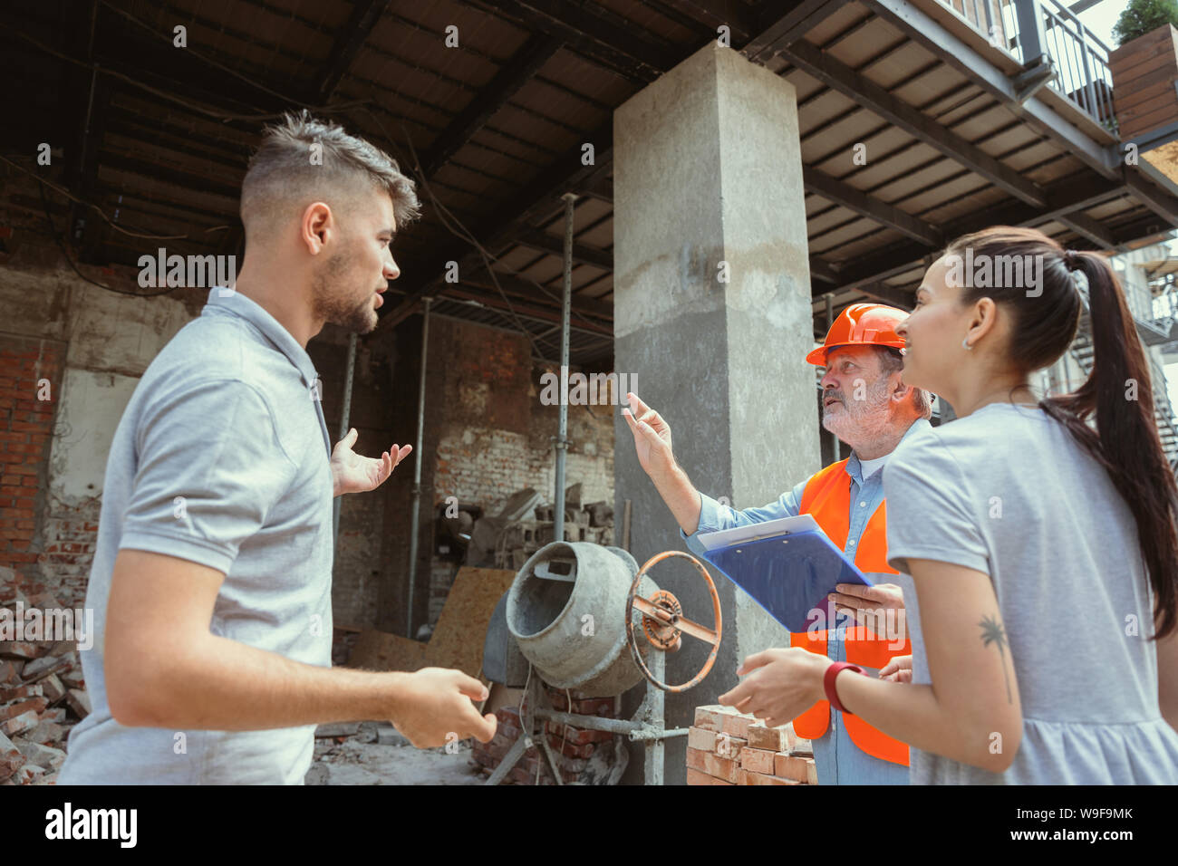 Foreman or achitect engineer shows future house, office or store design ...