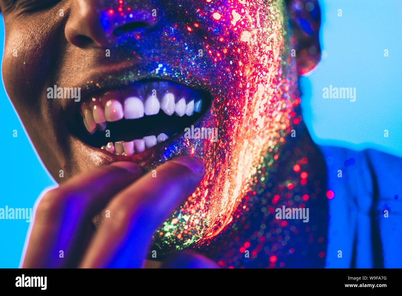 Handsome boy dancing at the rave party with fluorescent paintings on ...