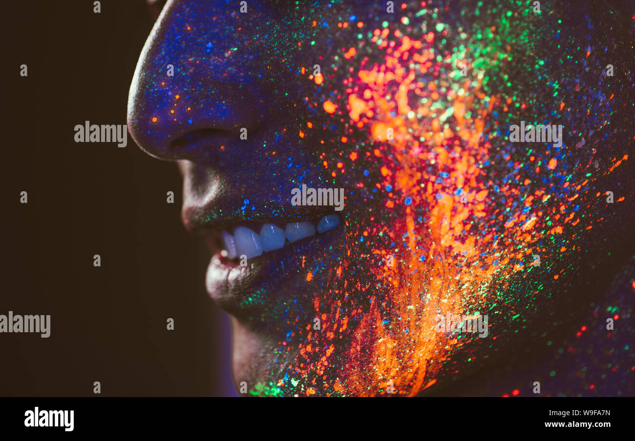 Handsome boy dancing at the rave party with fluorescent paintings on ...