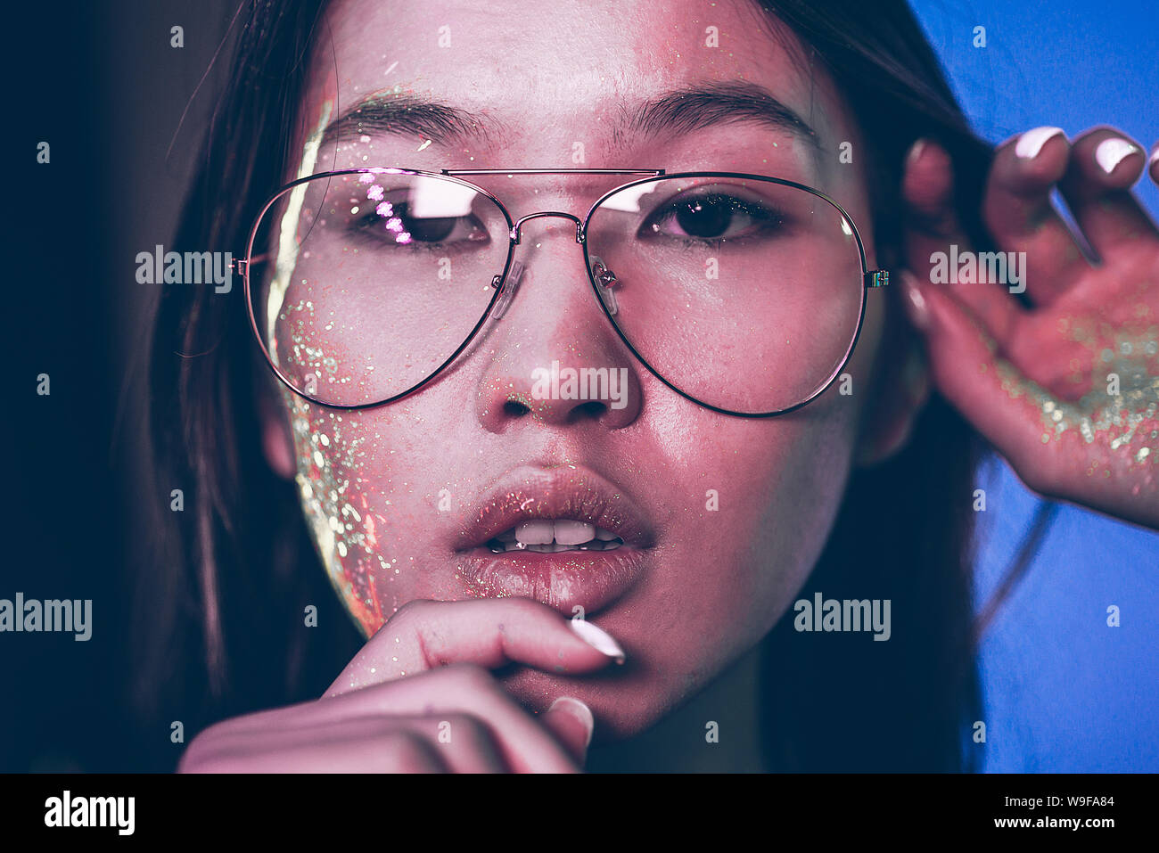 Beautiful young woman dancing and making party with fluorescent ...