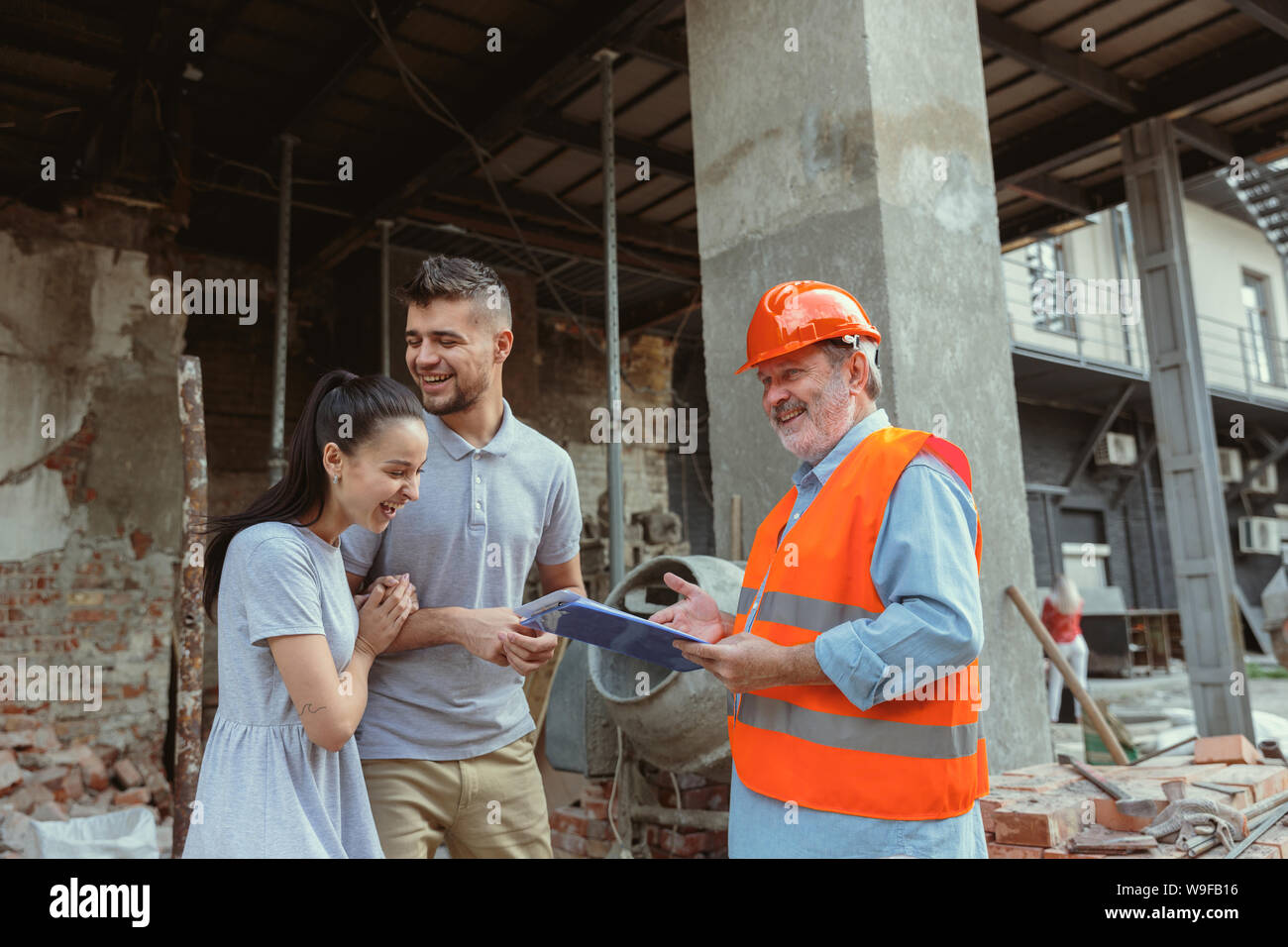 Foreman or achitect engineer shows future house, office or store design ...