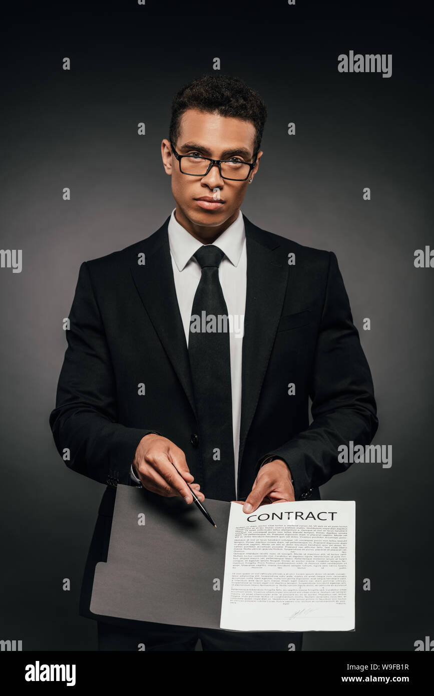 african american businessman showing contract on dark background Stock ...