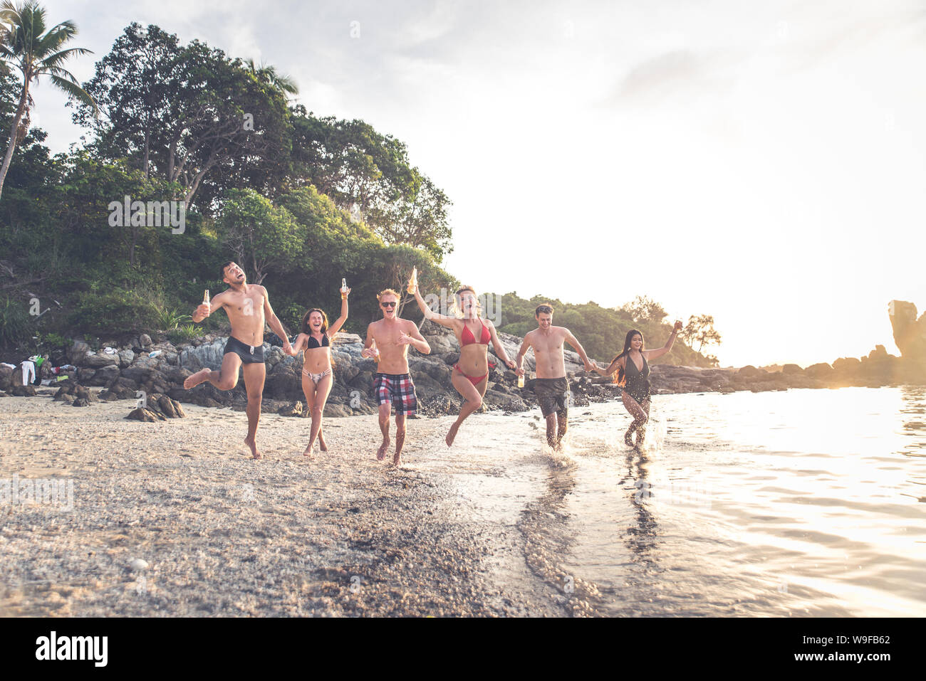 Group of friends having fun on the beach on a lonely island Stock Photo ...