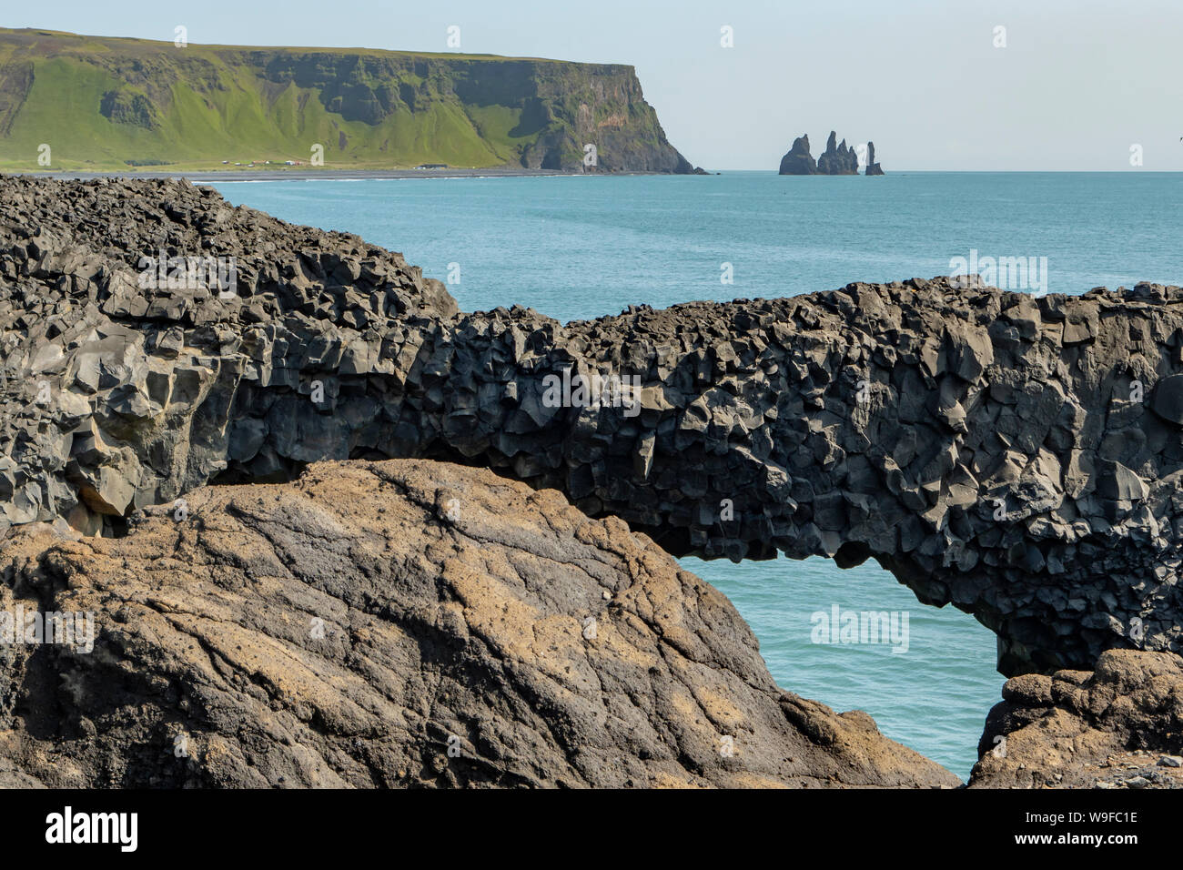 Small Arch at Dyrhoelay with Reynisdrangar Rocks, Iceland Stock Photo ...