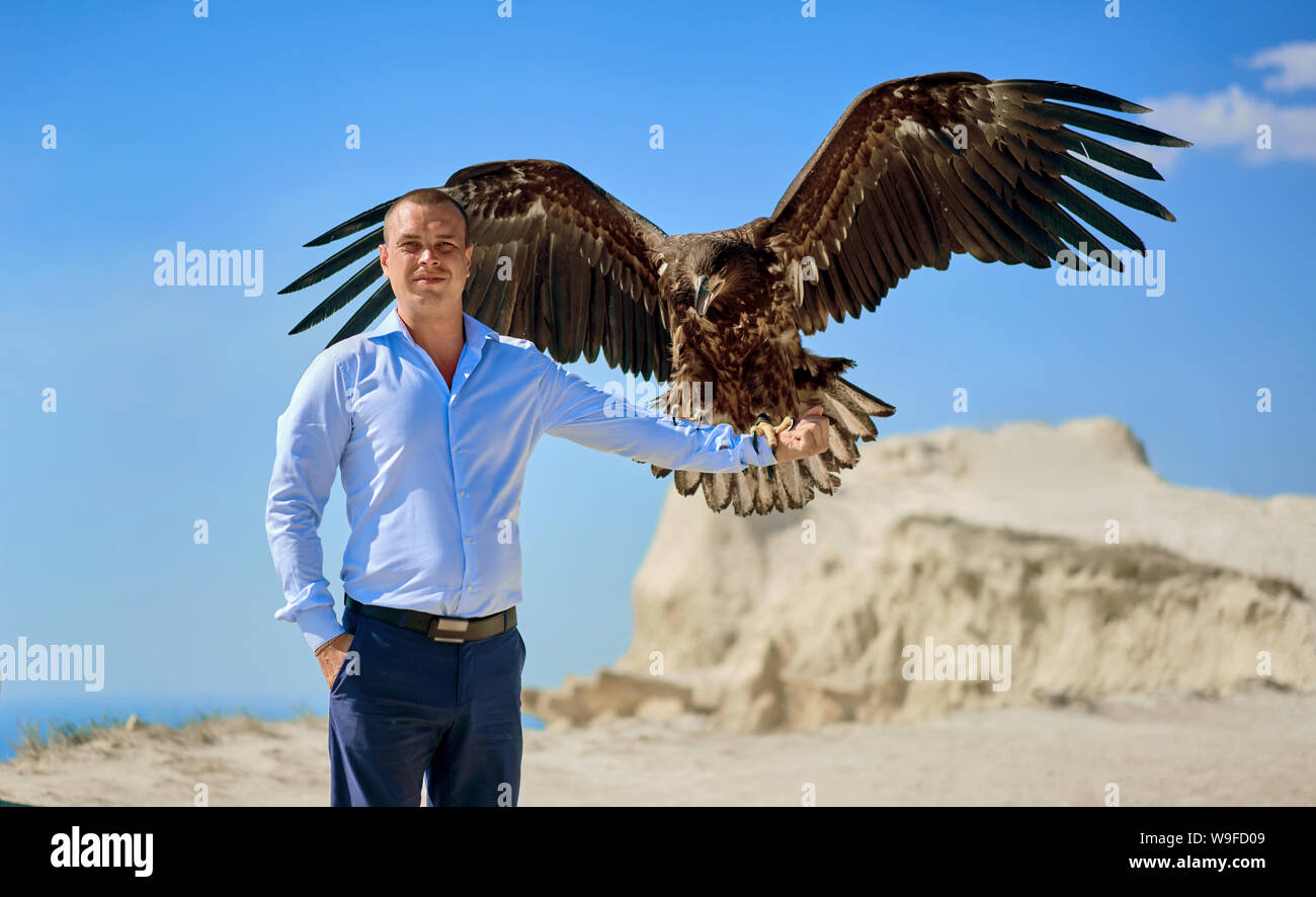 man in a shirt with an eagle on his hand Stock Photo - Alamy