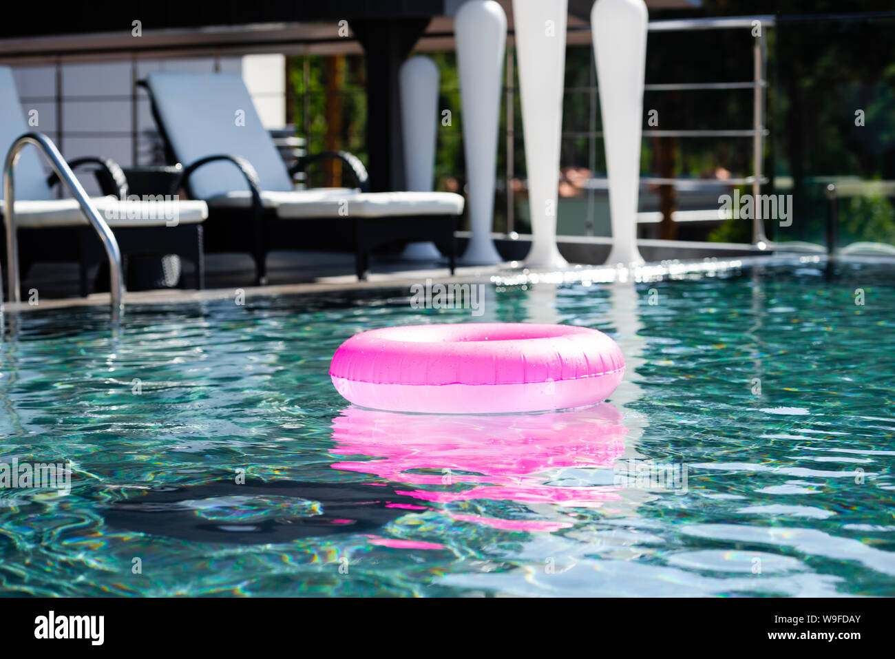 pink inflatable ring in swimming pool on resort during daytime Stock ...