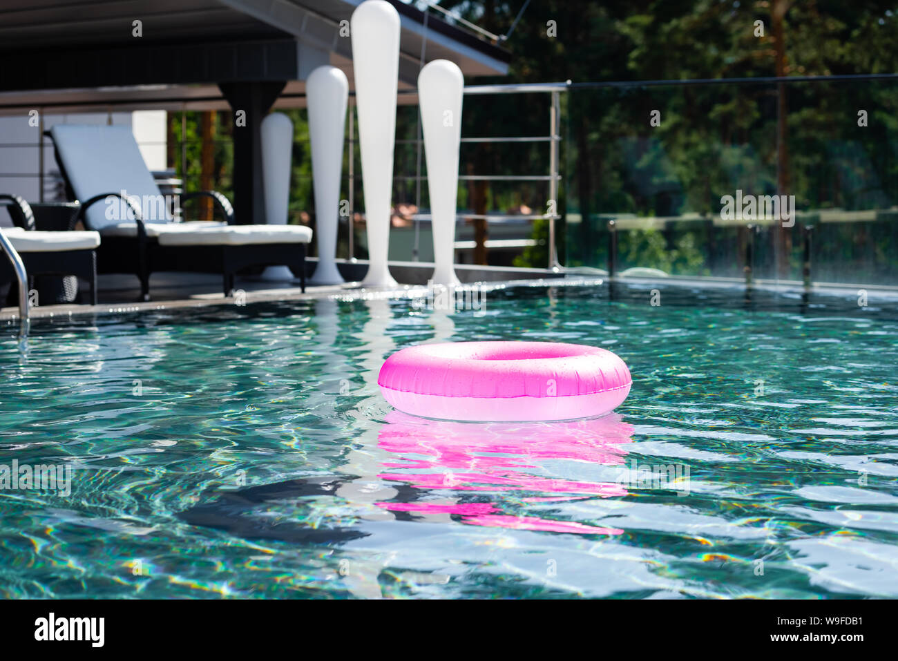 pink inflatable ring in swimming pool on resort during daytime Stock ...