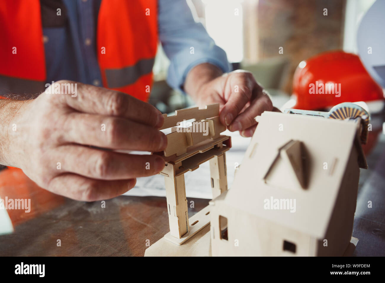 Close up photoshot of male architect-engineer making a model of future ...