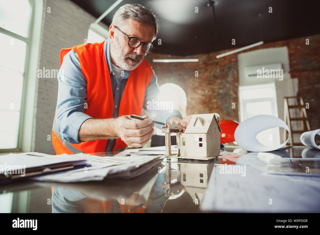 Close up photoshot of male architect-engineer making a model of future ...