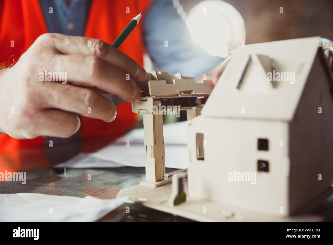 Close up photoshot of male architect-engineer making a model of future ...