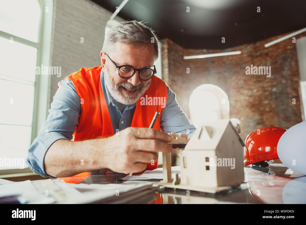 Close up photoshot of male architect-engineer making a model of future ...