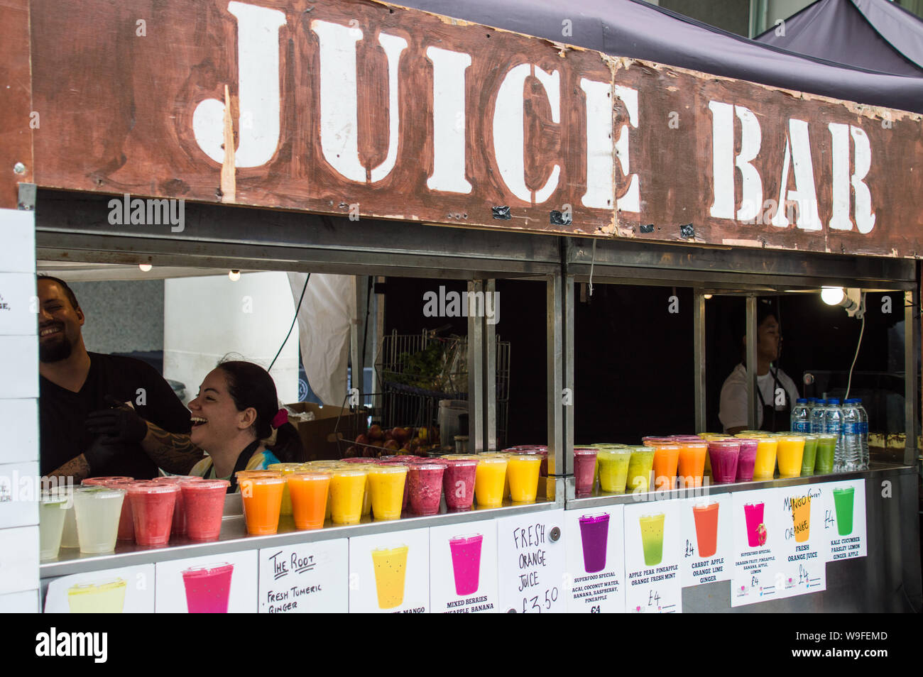 Juice Bar with several mixed juices on display in a plastic transparent ...