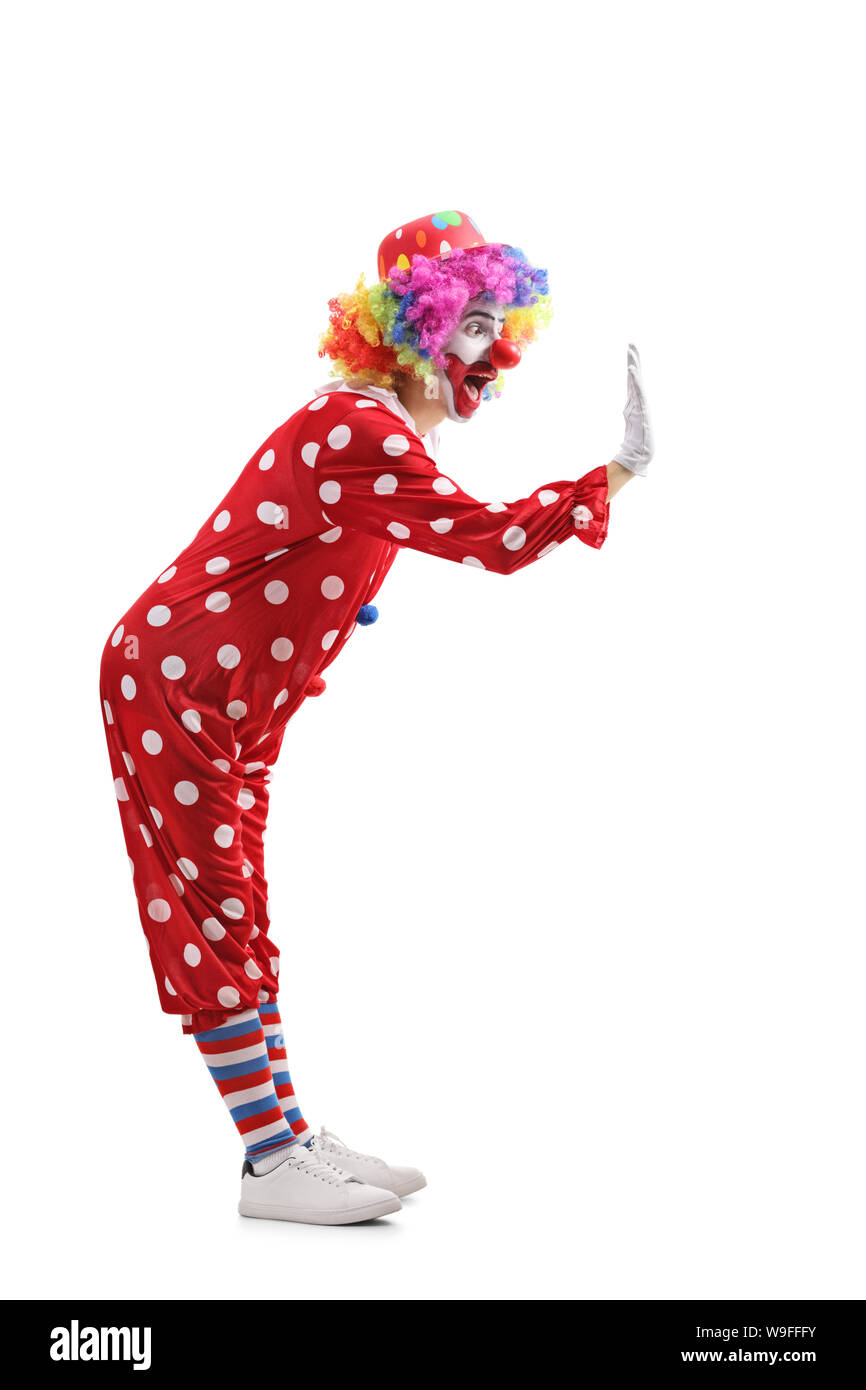 Full length profile shot of a cheerful clown gesturing high-five ...