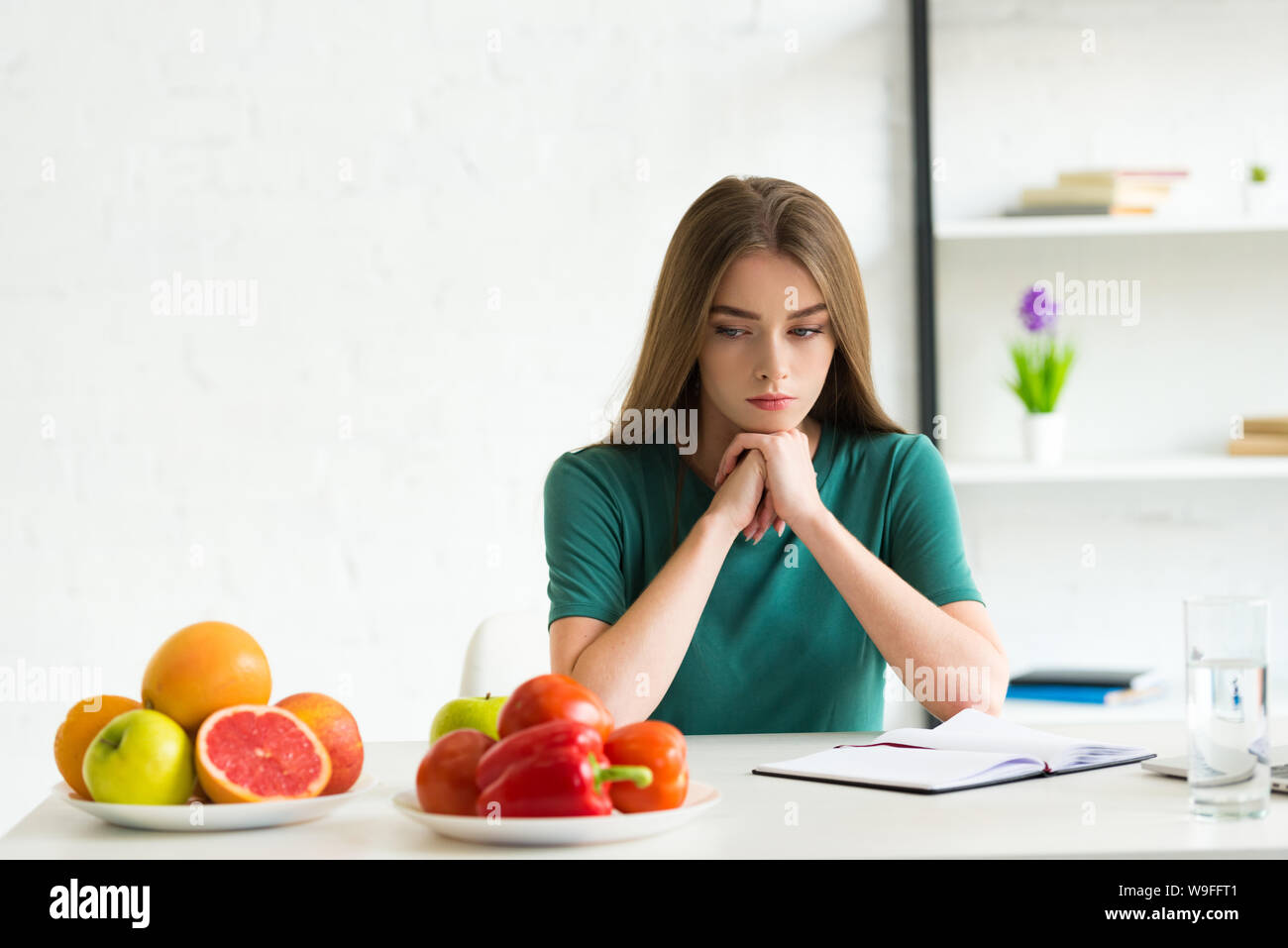 Sad woman eating at table hi-res stock photography and images - Alamy