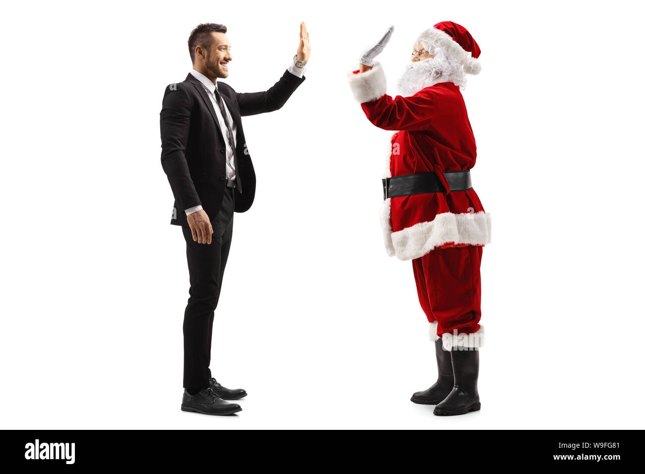 Full length profile shot of Santa Claus and a businessman gesturing ...