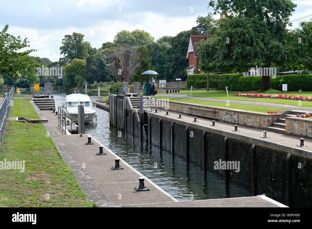 A private leisure river cruiser passing through Shepperton lock on a ...