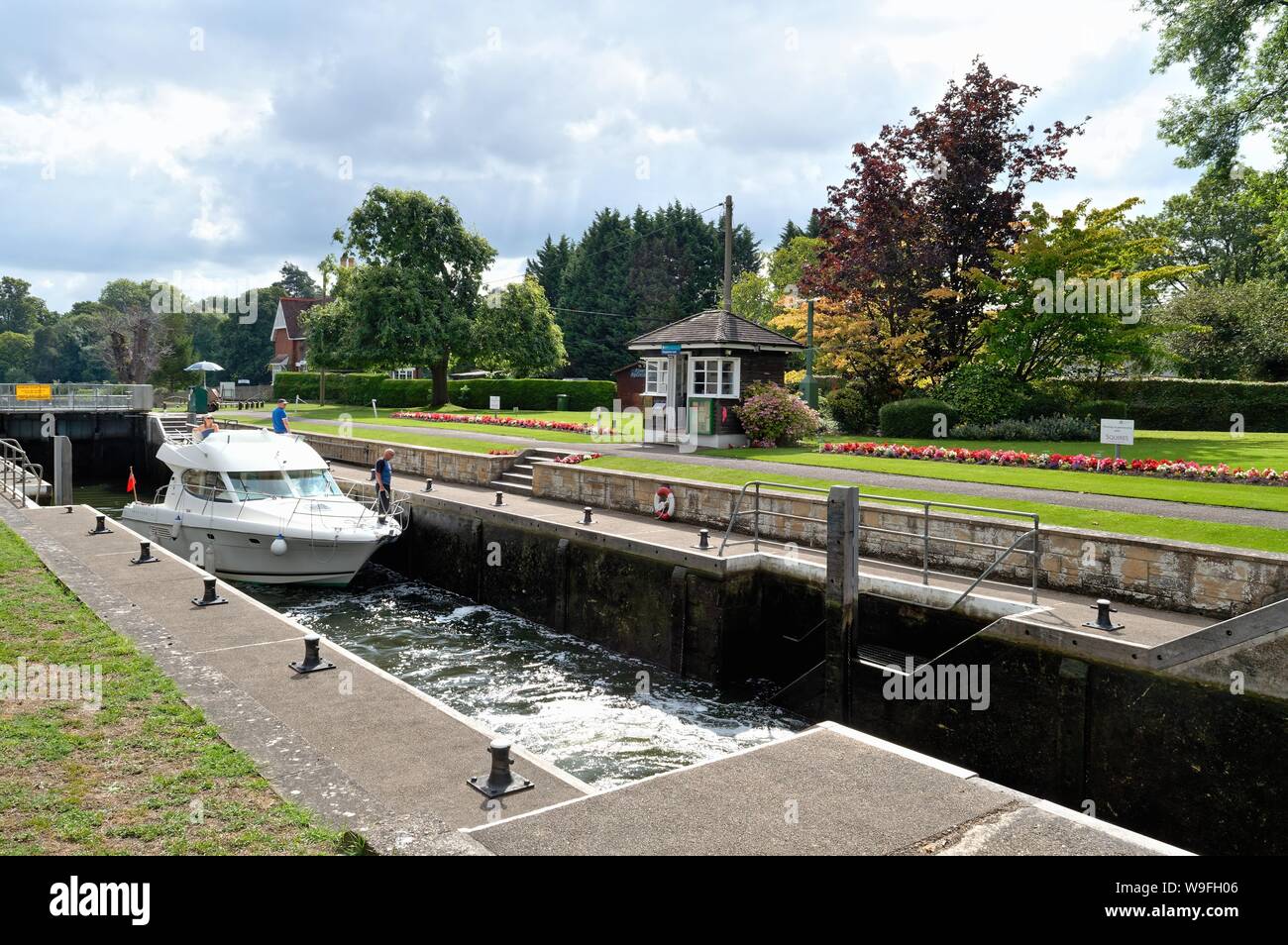 A private leisure river cruiser passing through Shepperton lock on a ...