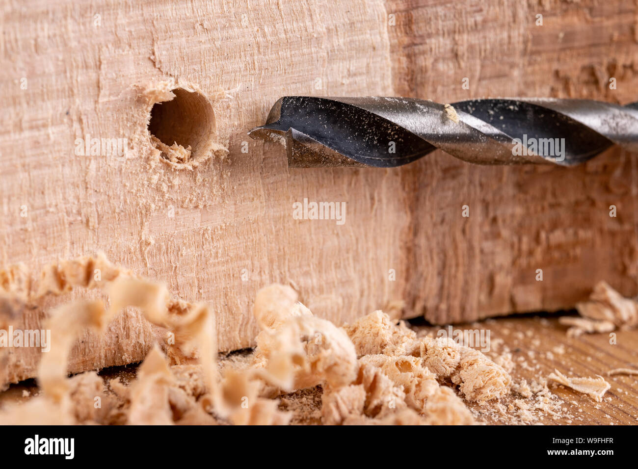Drilling holes in raw wood. Carpentry drill in a carpentry workshop ...