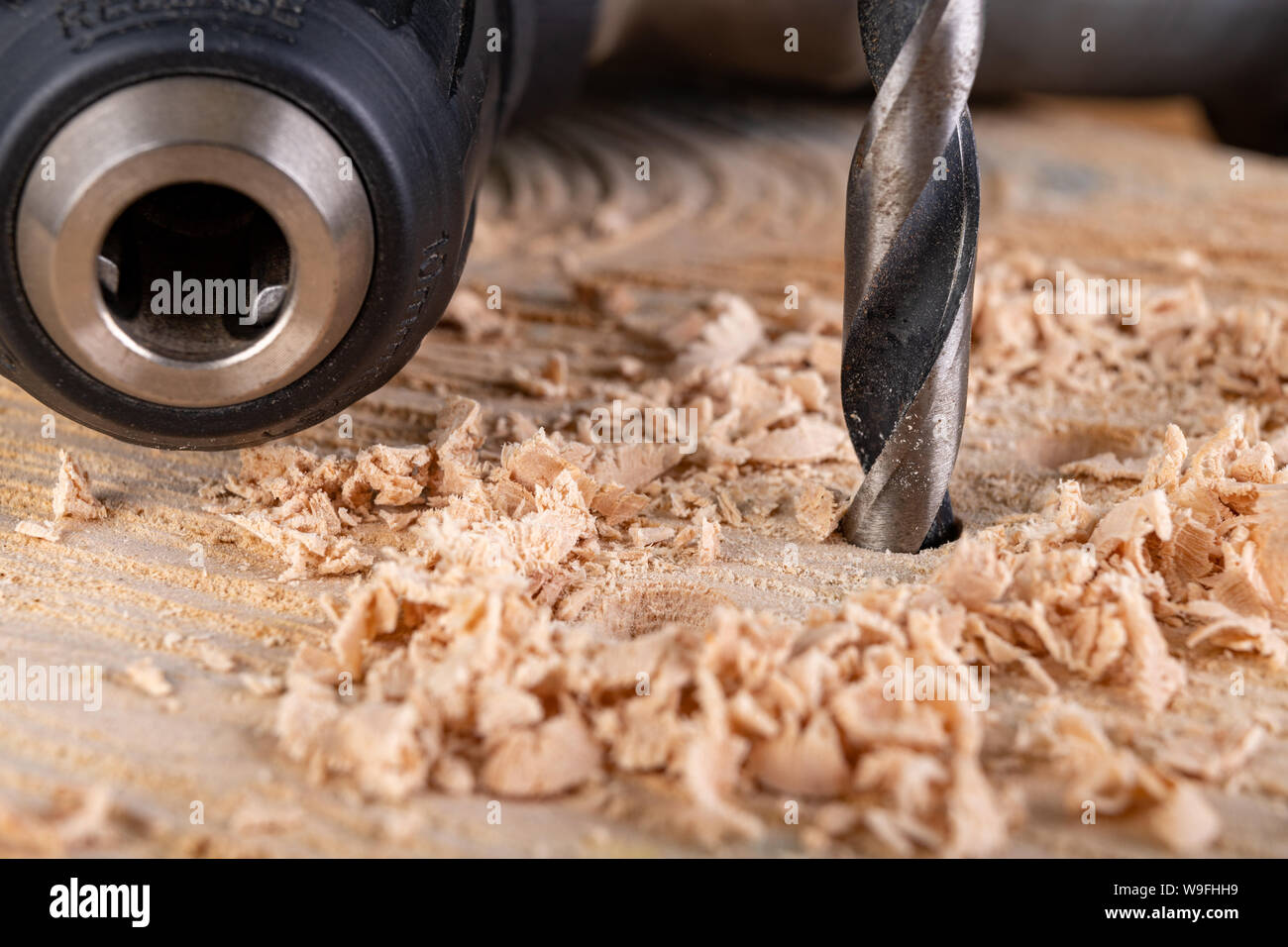Drilling holes in raw wood. Carpentry drill in a carpentry workshop ...