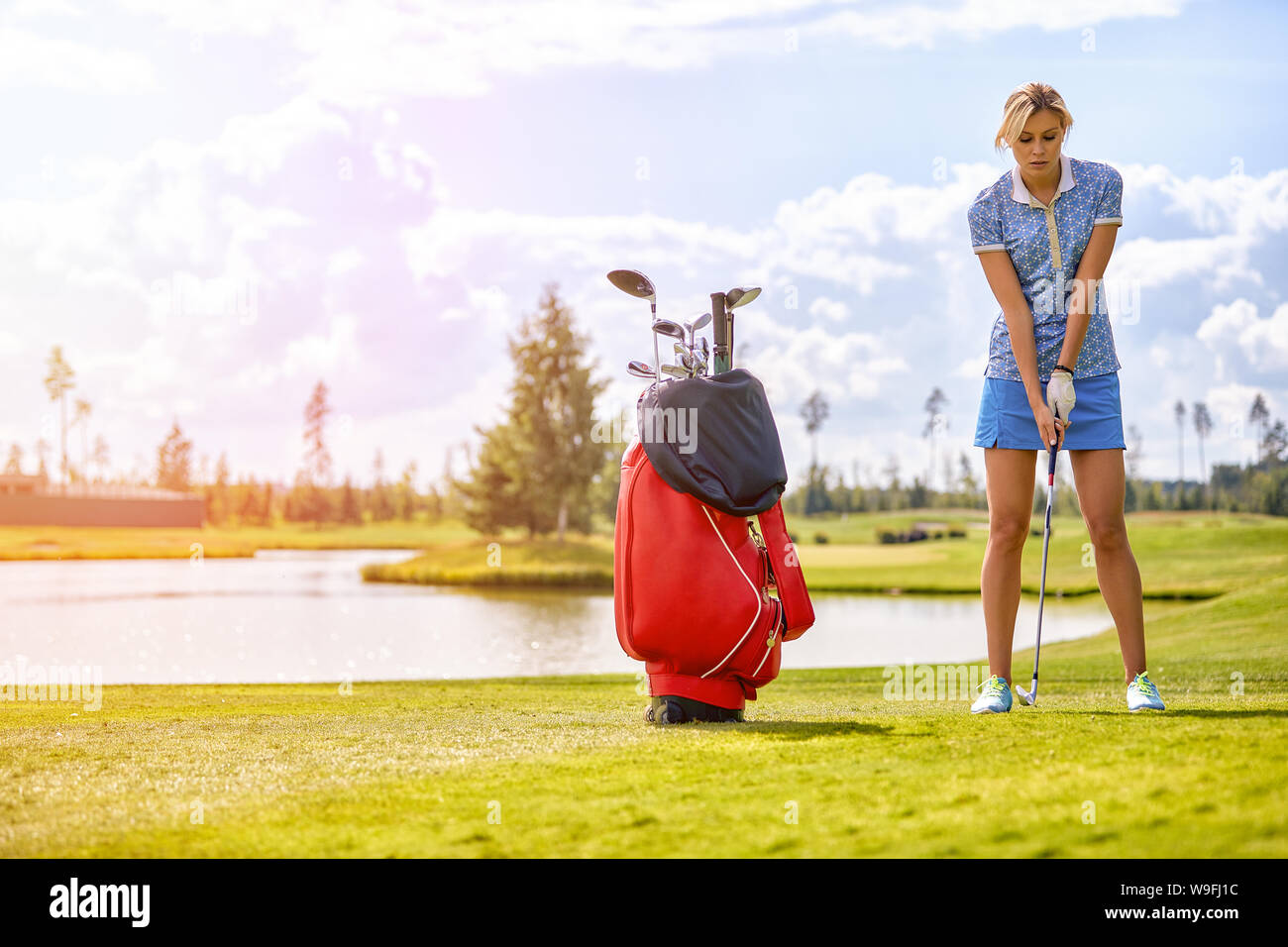 Golf course, a beautiful girl getting ready to hit the ball. Lifestyle ...