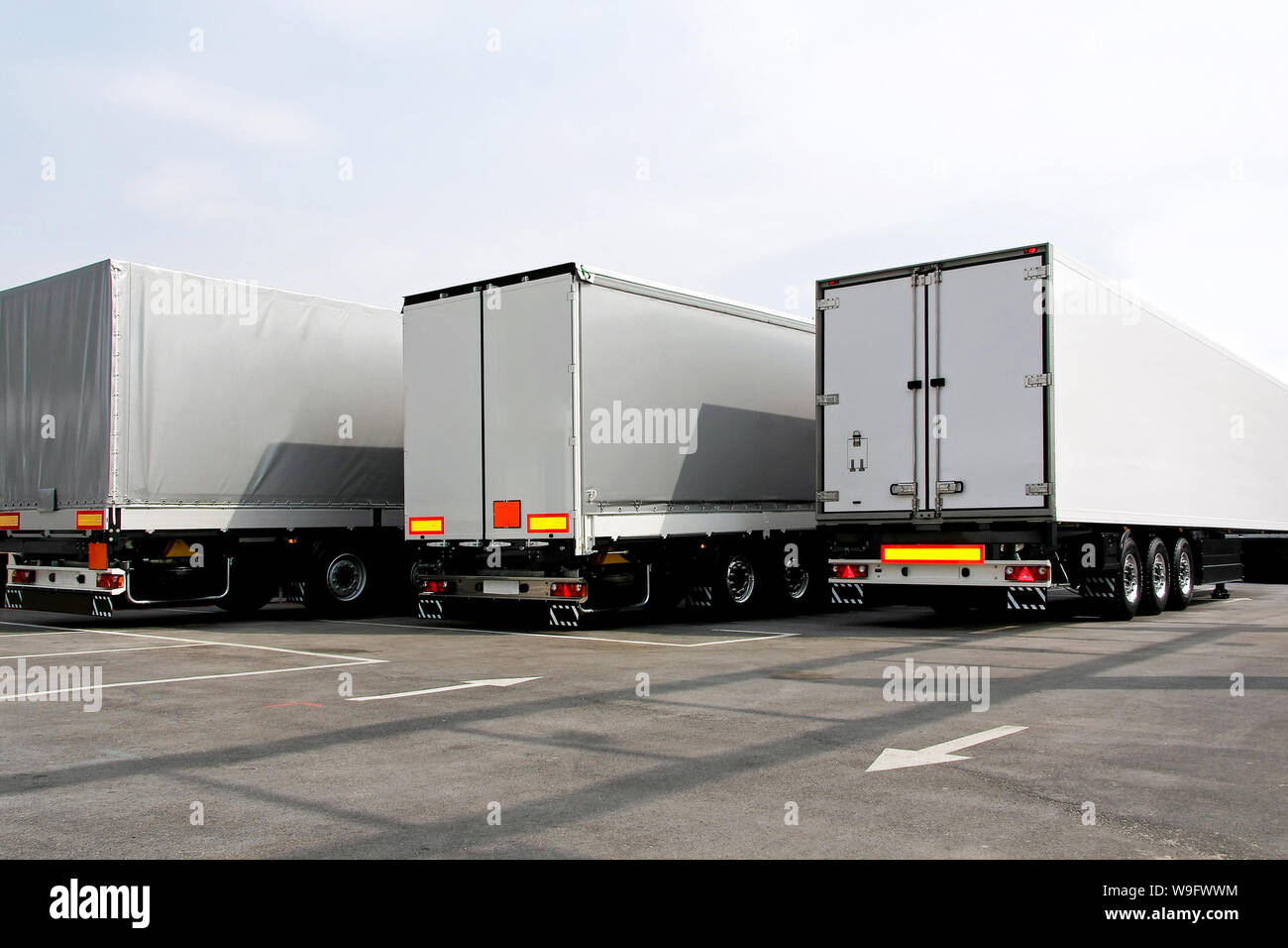 Three lorries of semi truck at parking Stock Photo - Alamy