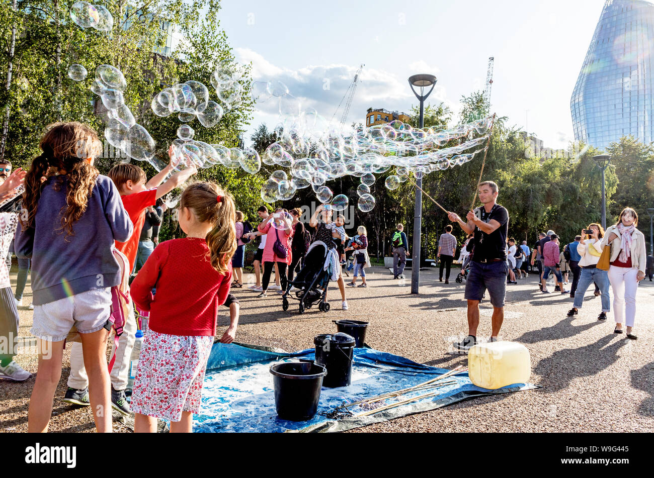 Children On The South Bank Playing With Bubbles London UK Stock Photo ...