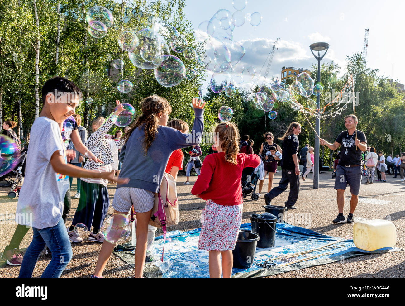 Children On The South Bank Playing With Bubbles London UK Stock Photo ...