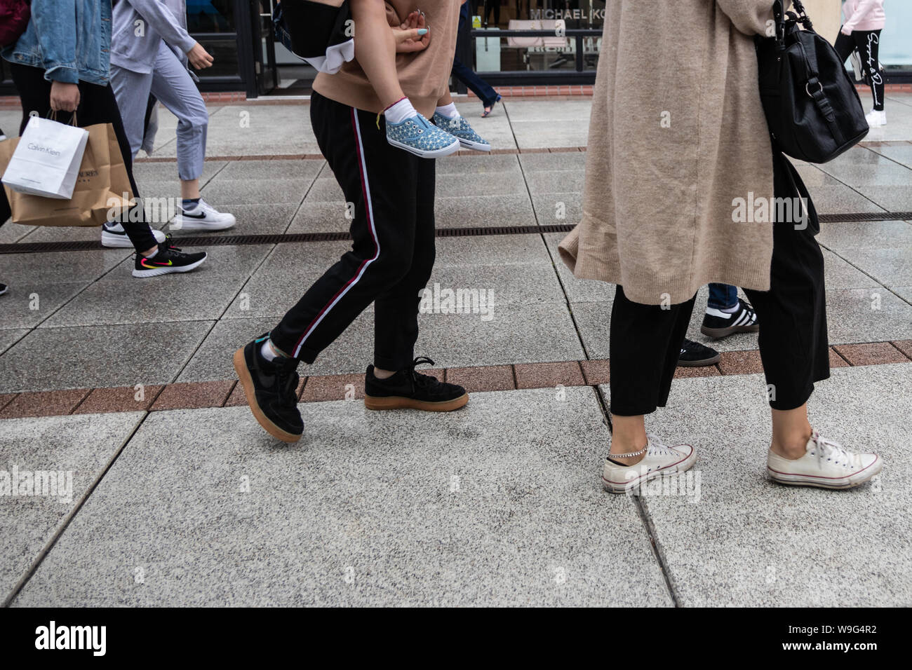 People walking past the camera in the street Stock Photo - Alamy