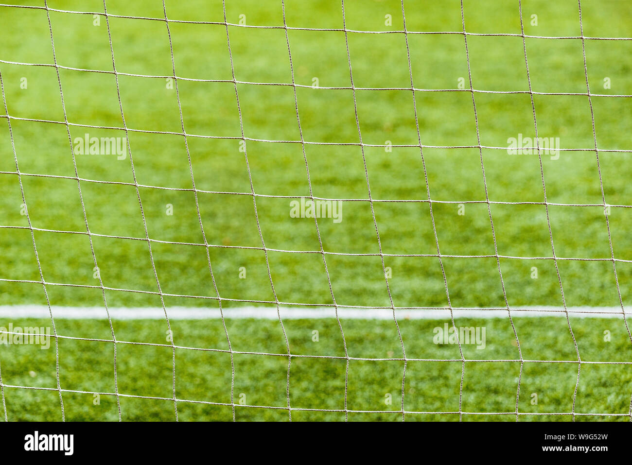 Soccer gate net on the green grass background Stock Photo - Alamy