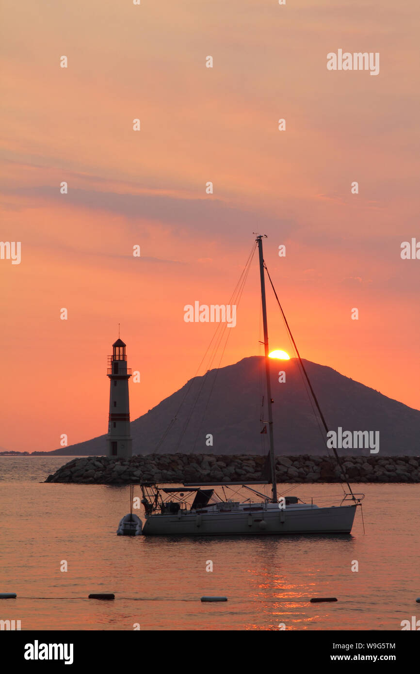 Seascape at sunset. Lighthouse on the coast Stock Photo - Alamy