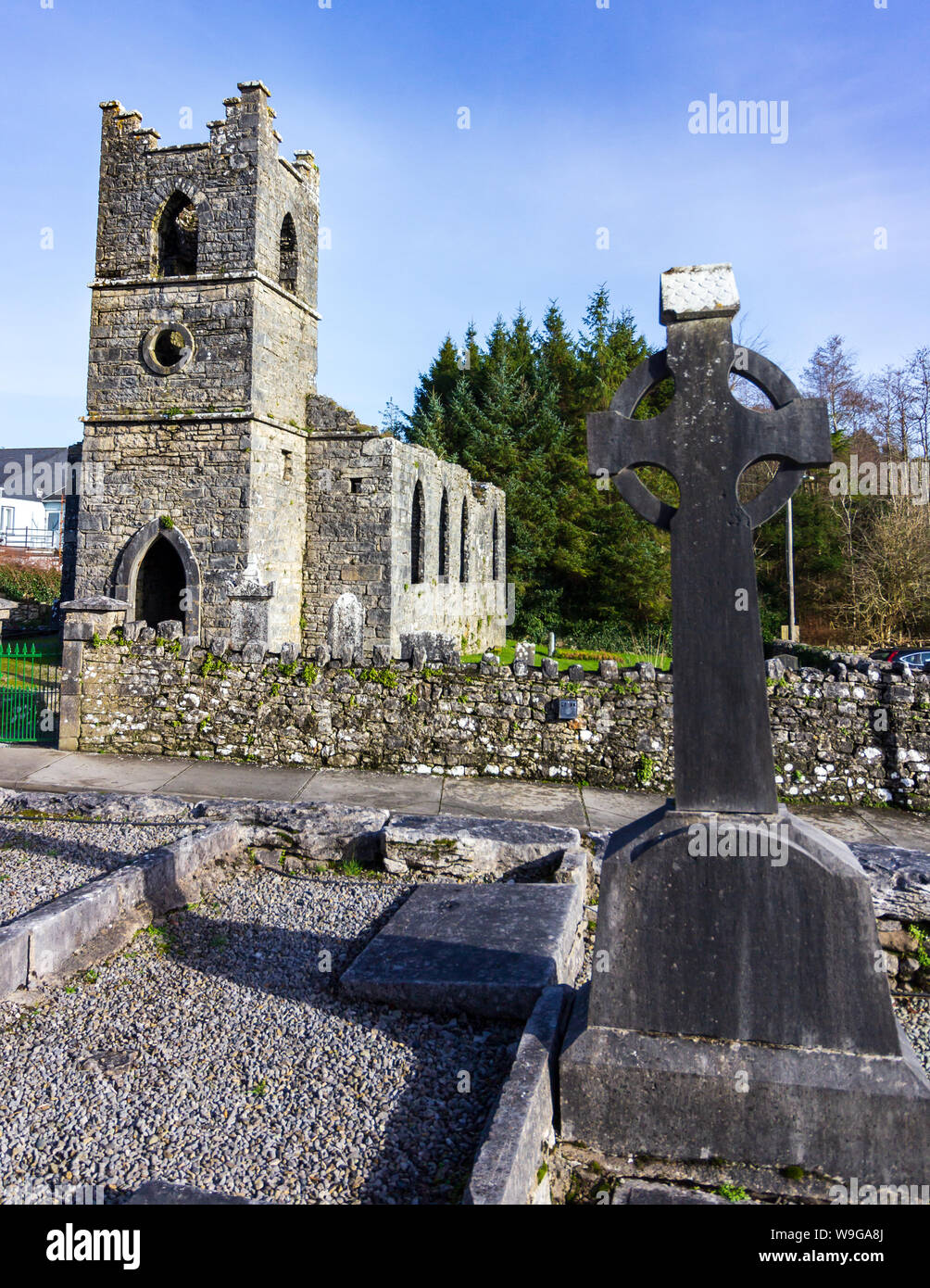 Gravestone in the shape of a Celtic cross with Saint Mary of the Rosary ...
