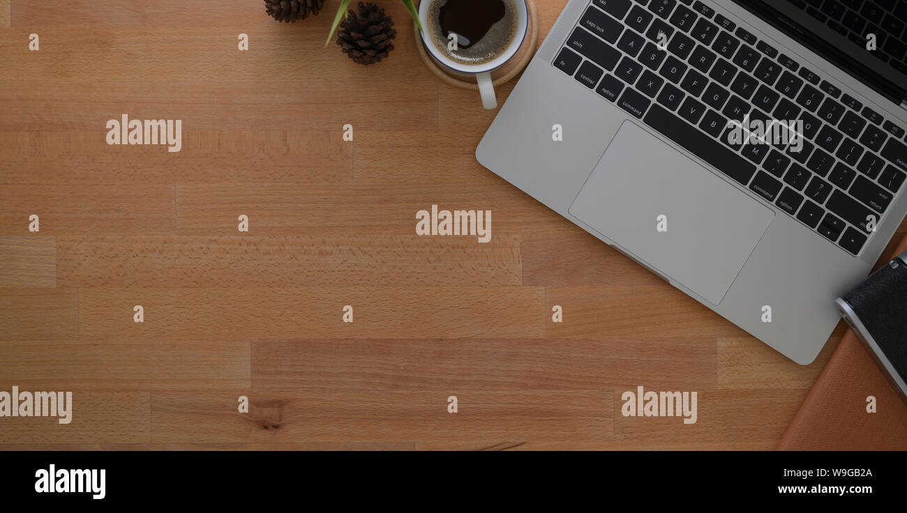 Overhead shot of comfortable workplace with laptop computer and office ...