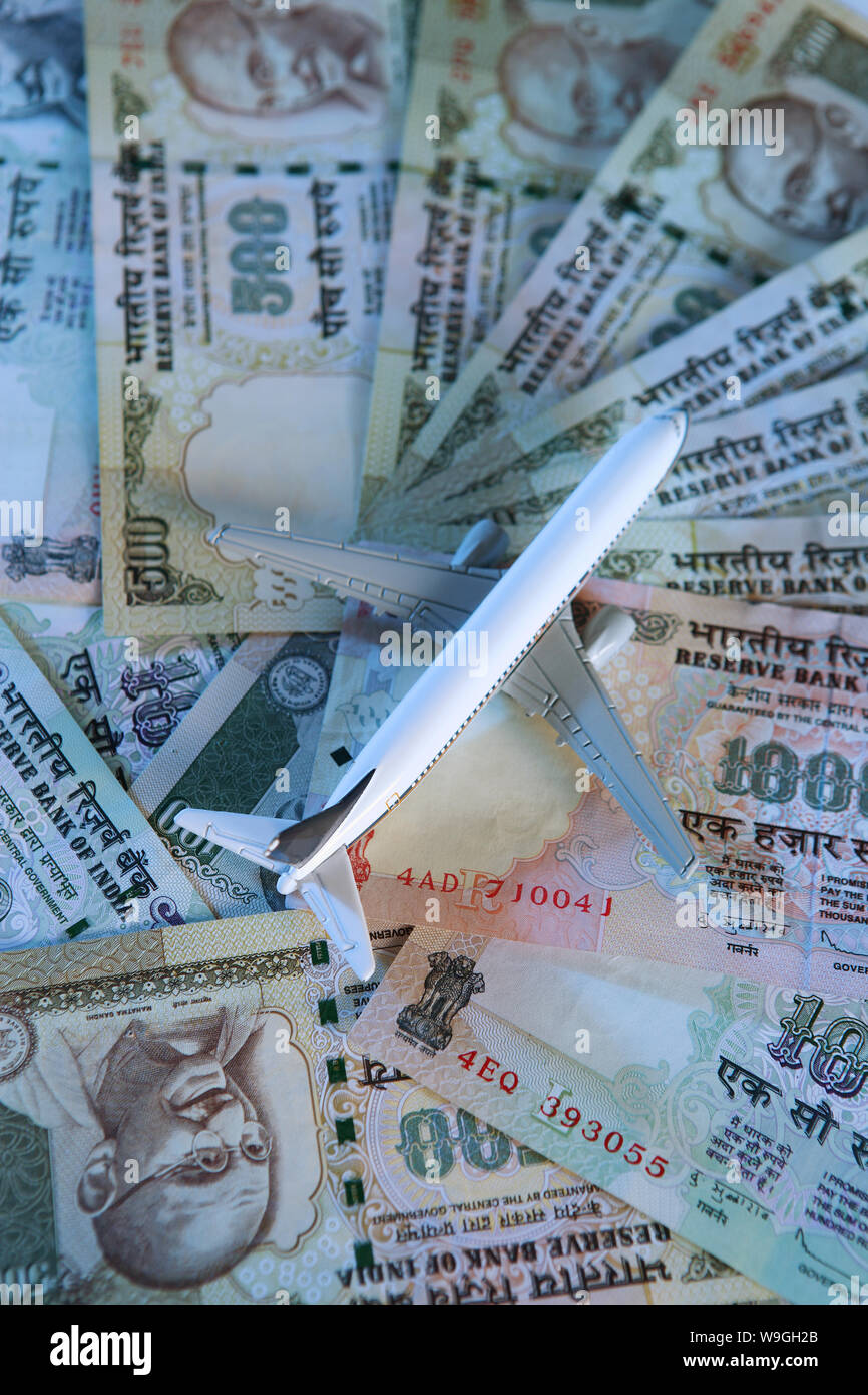 High angle view of model airplane with Indian currency Stock Photo - Alamy