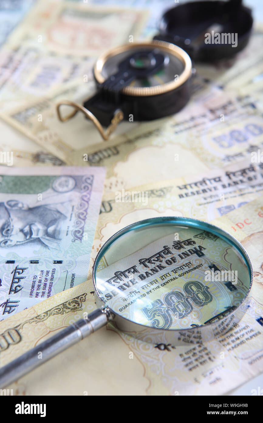 Magnifying glass with Indian currency Stock Photo - Alamy
