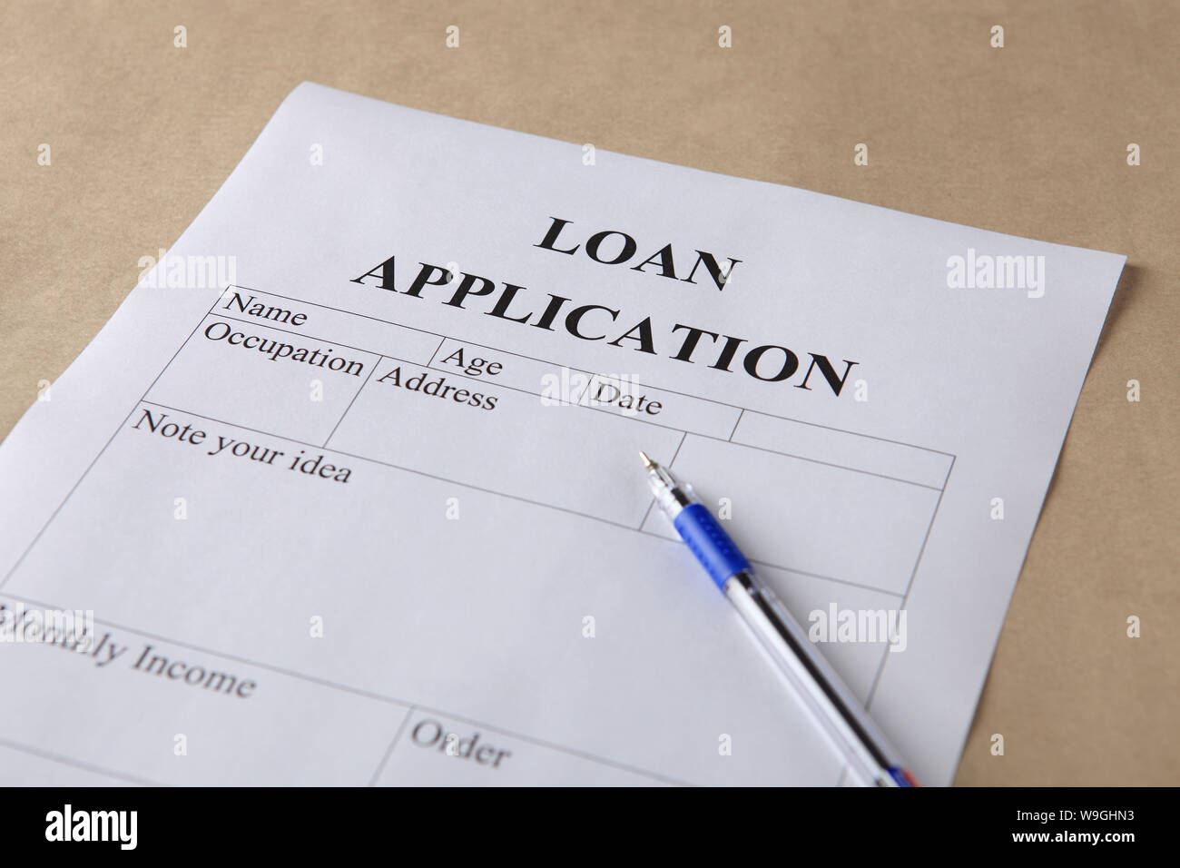 Pen on loan application form Stock Photo - Alamy