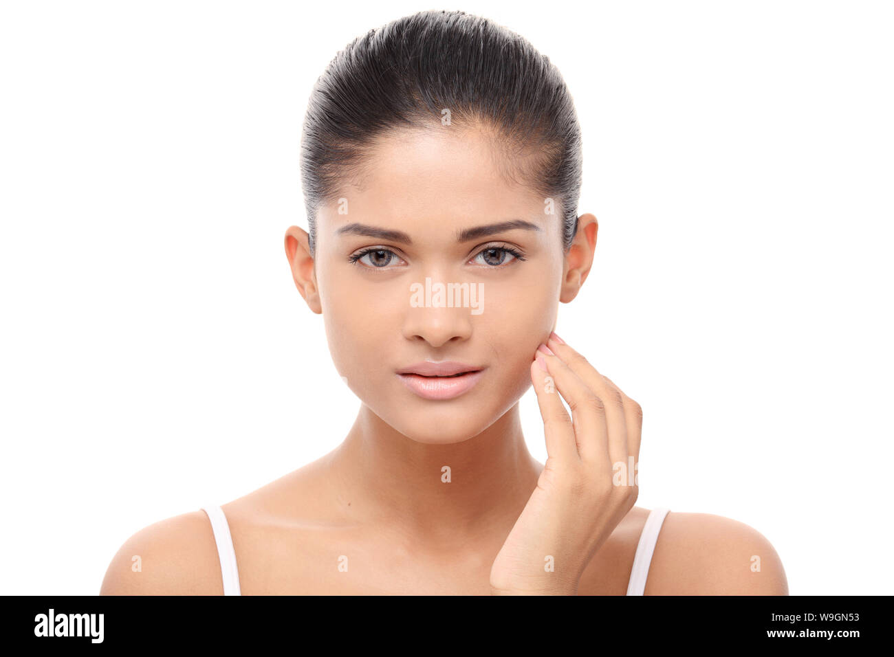 Portrait of a beautiful young woman touching her cheek Stock Photo - Alamy