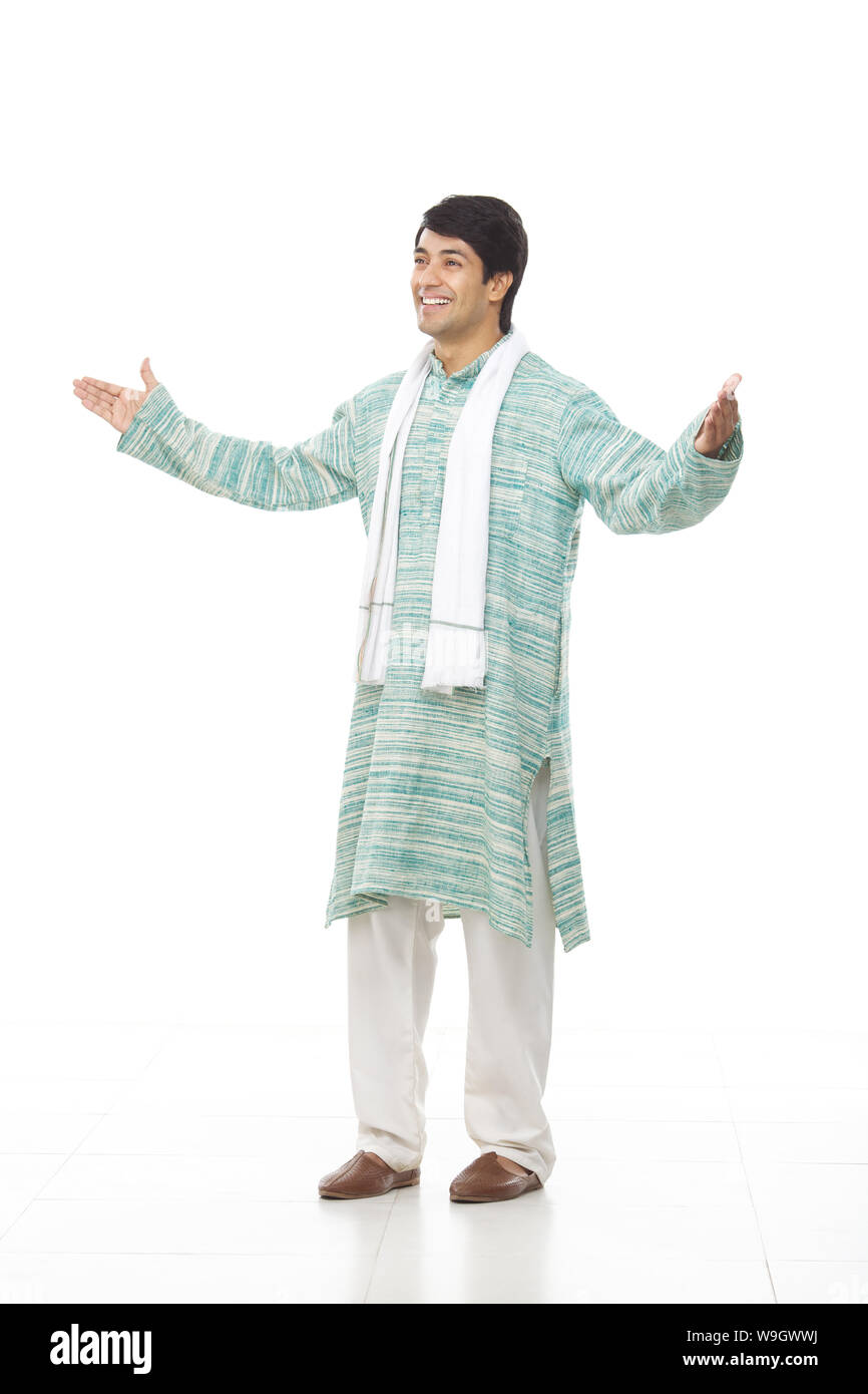 Rural man standing with his arm outstretched Stock Photo - Alamy