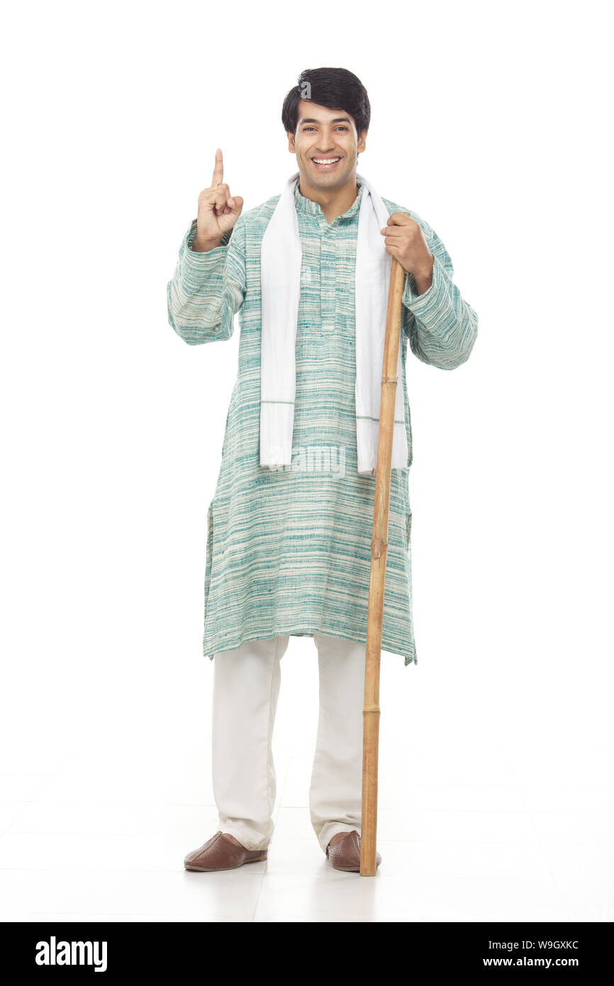 Rural man standing and pointing upward Stock Photo - Alamy