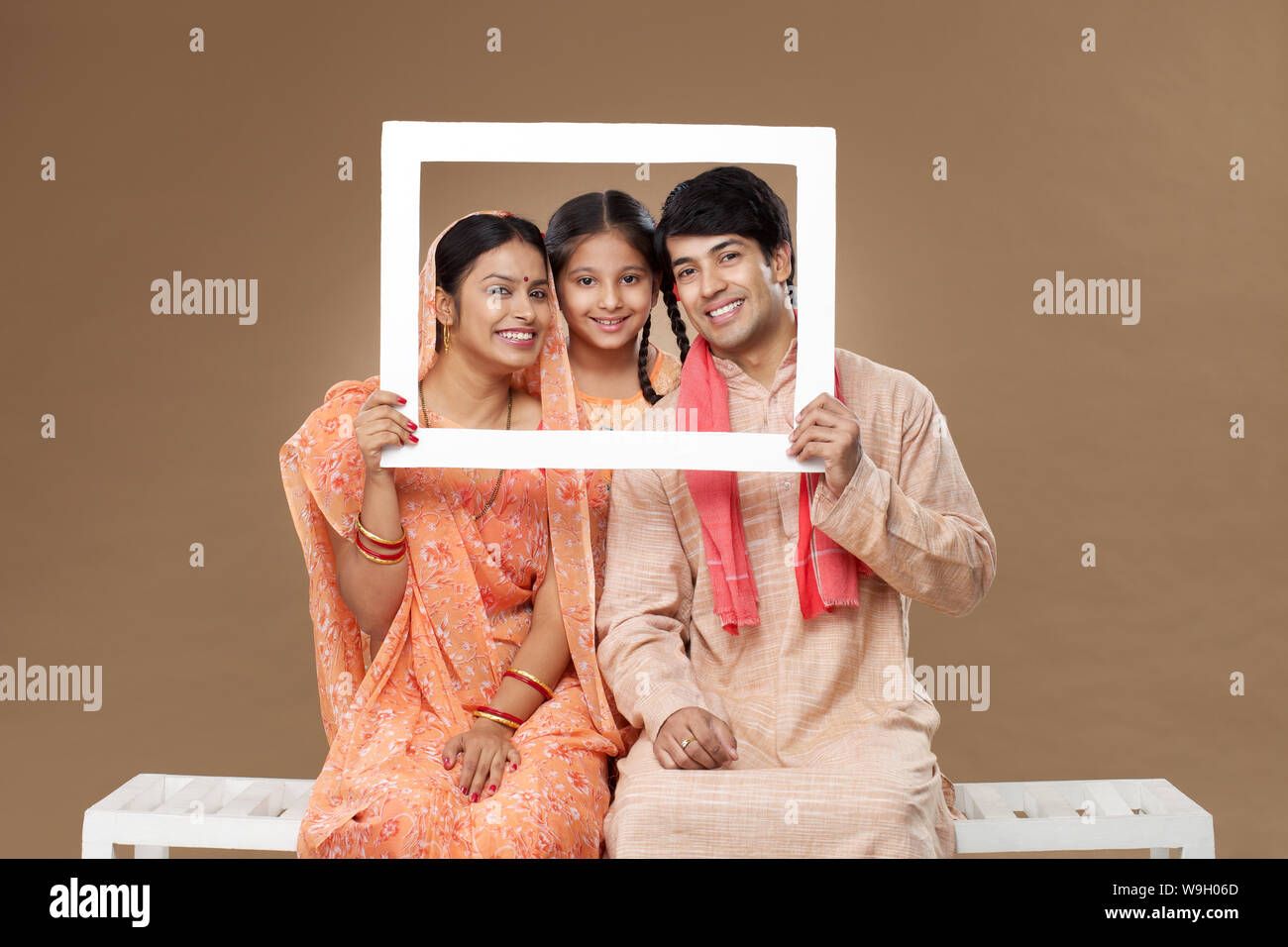 Rural family looking through empty frame Stock Photo - Alamy