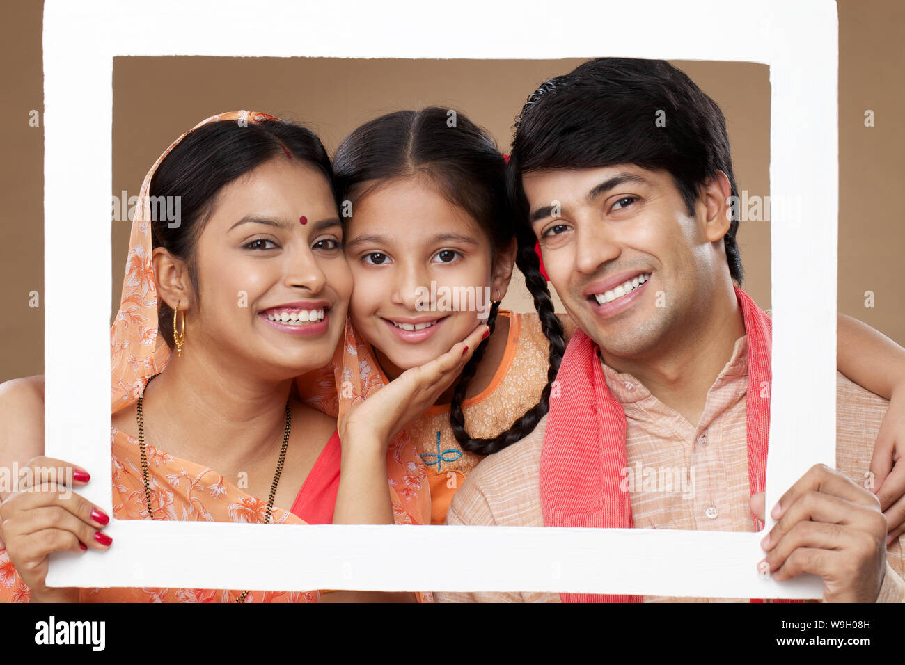 Rural family looking through empty frame Stock Photo - Alamy