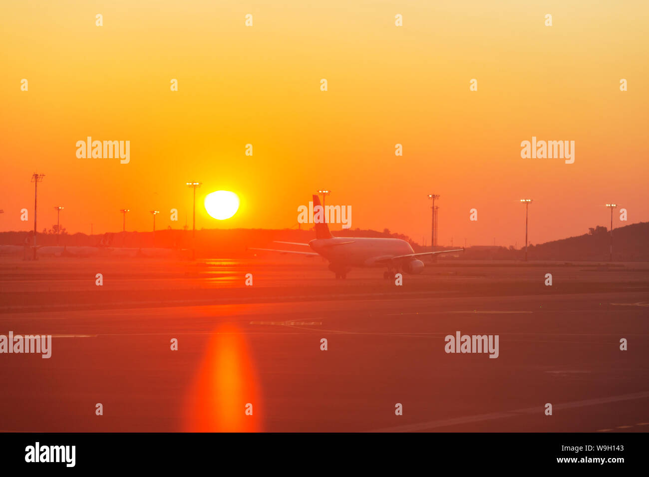 Aircraft in airport at sunrise Stock Photo - Alamy