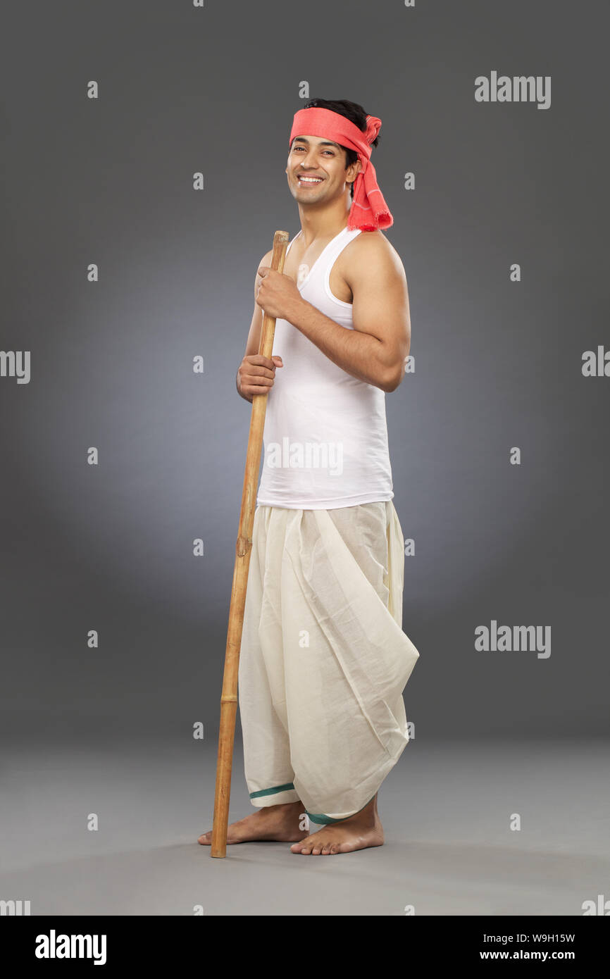 Rural man standing with his cane Stock Photo - Alamy