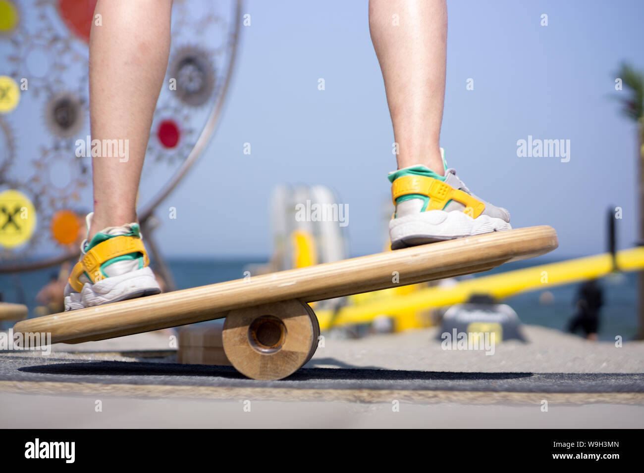 Balancing on a balance board in sunny weather at the beach Stock Photo ...