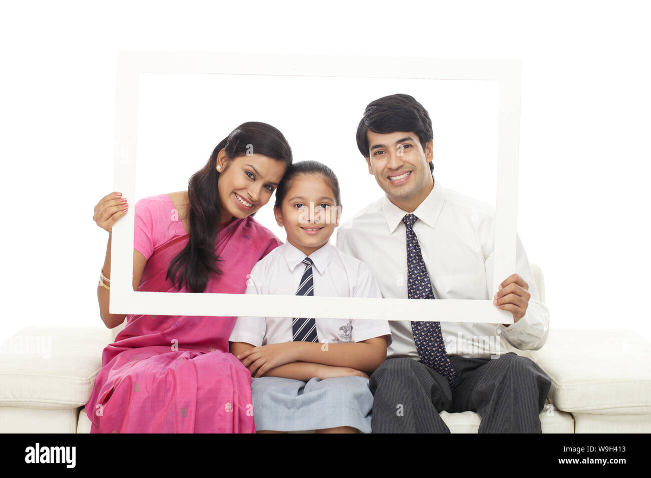 Young family looking through an empty frame Stock Photo - Alamy
