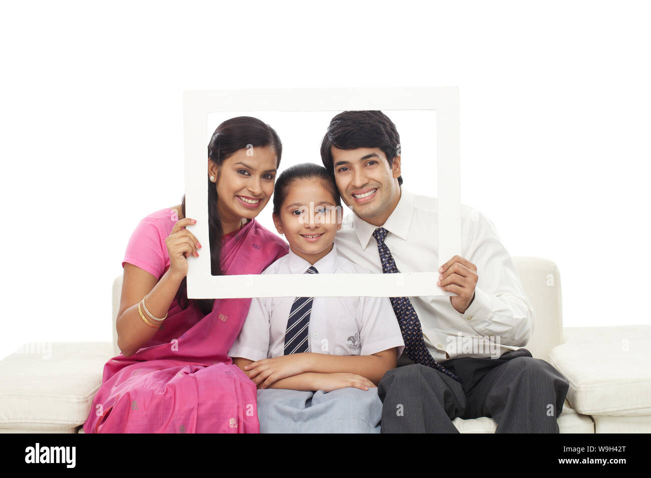 Young family looking through an empty frame Stock Photo - Alamy
