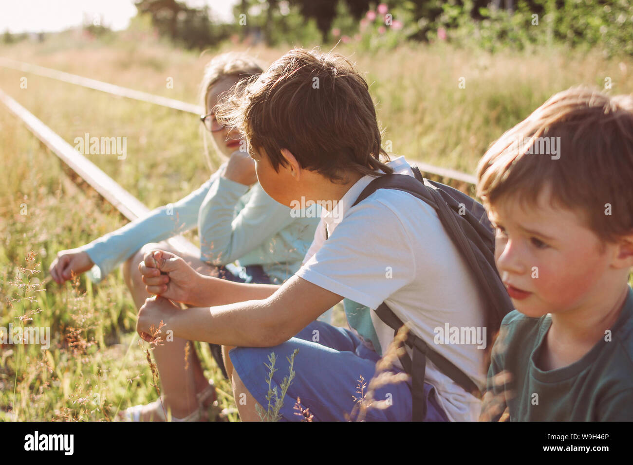 Group of children tweens on railway on sunset, summer time in the ...