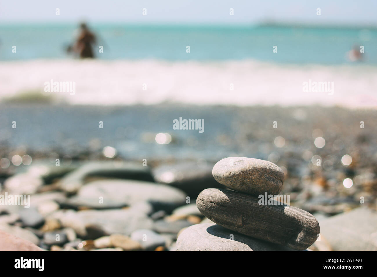 Pile of pebbles stones on the blurred sea beach background Stock Photo ...