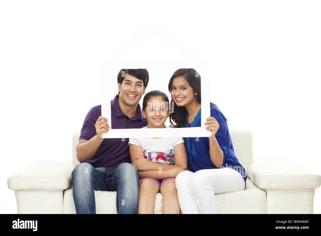Young family looking through an empty frame Stock Photo - Alamy