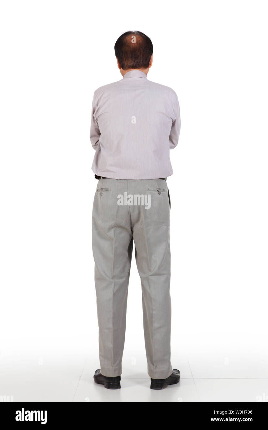 Rear view of a man standing Stock Photo - Alamy