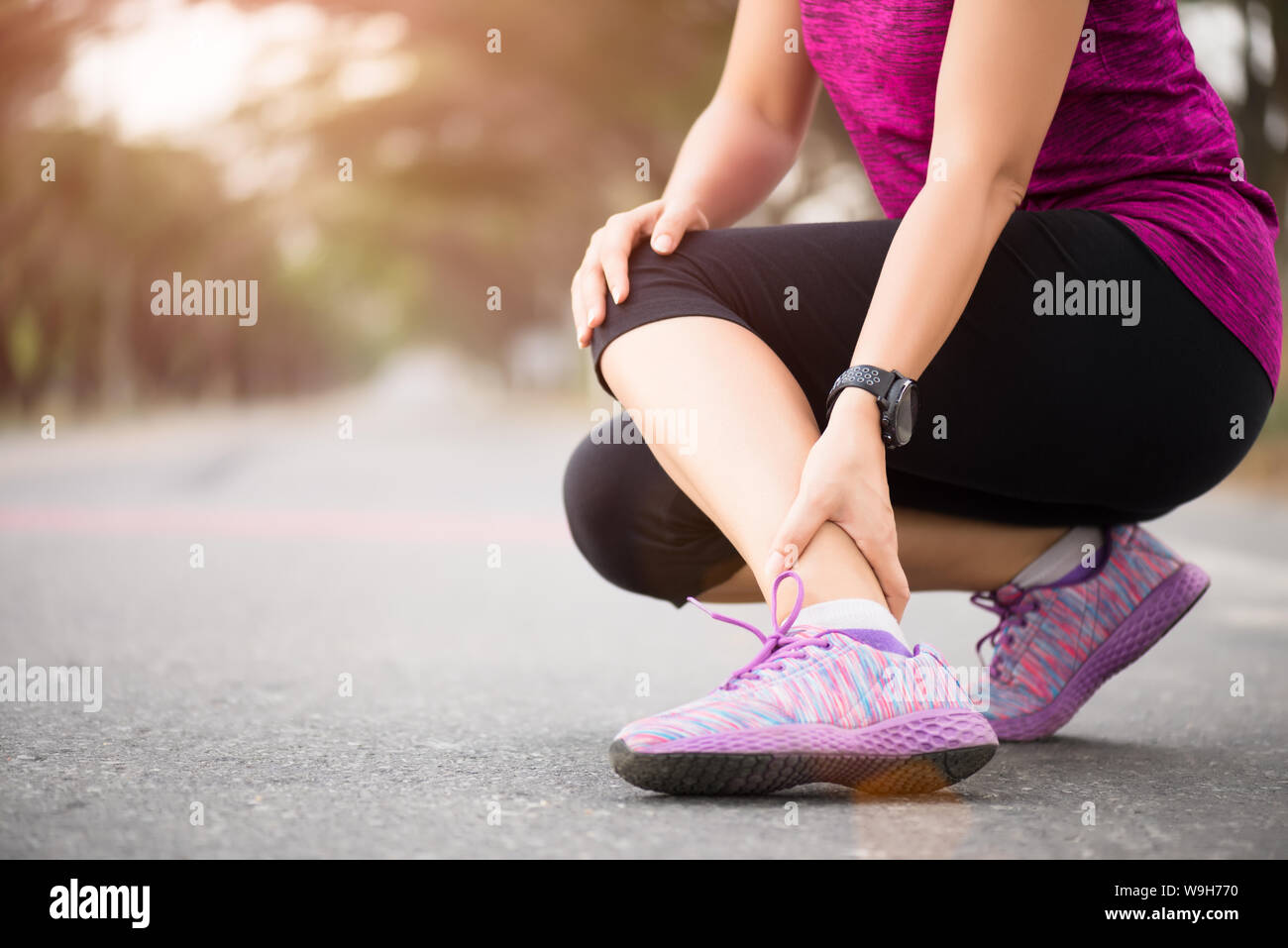 Woman suffering from an ankle injury while exercising. Running sport ...